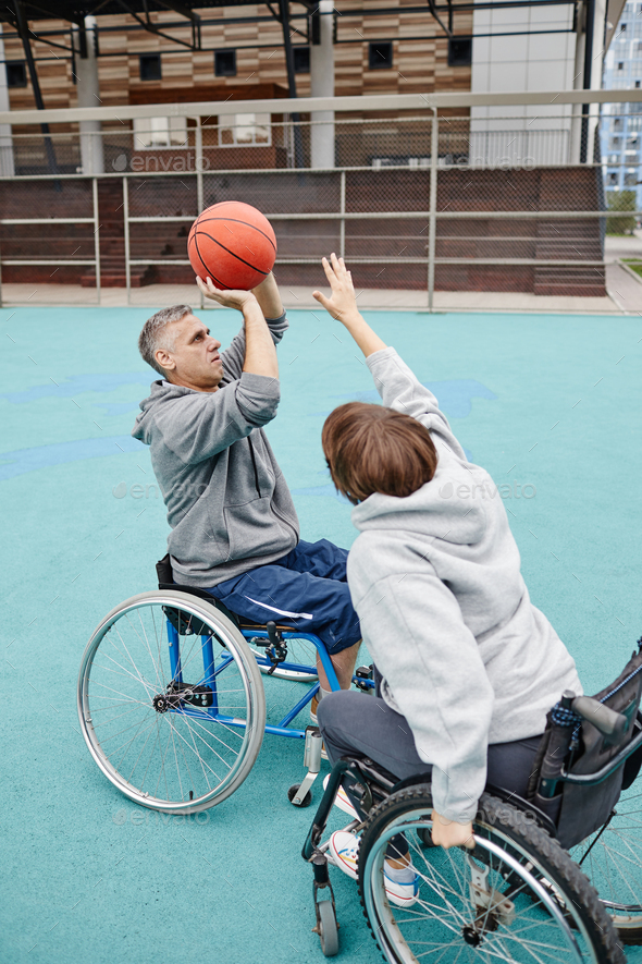 Paraplegic couple playing together Stock Photo by seventyfourimages