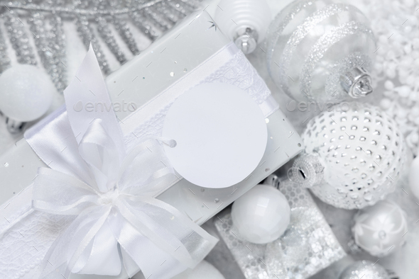 Christmas present with blank gift tag and white decorations, Mockup ...
