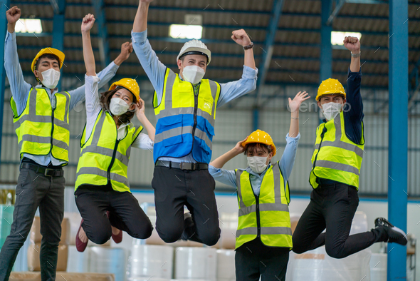 Group of factory workers man and woman jump with happy action in ...