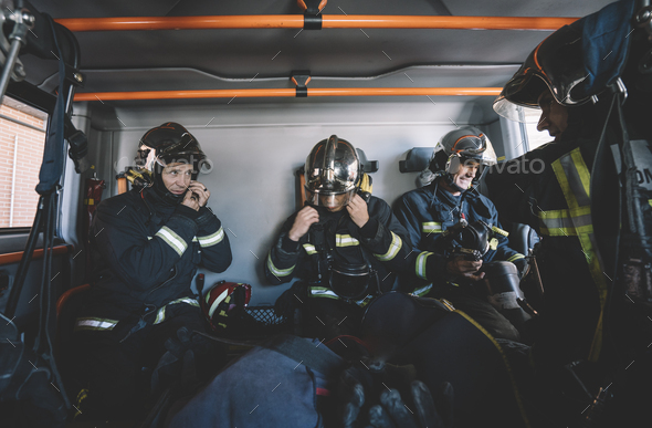 Firemen working inside an emergency vehicle. Stock Photo by ADDICTIVE_STOCK