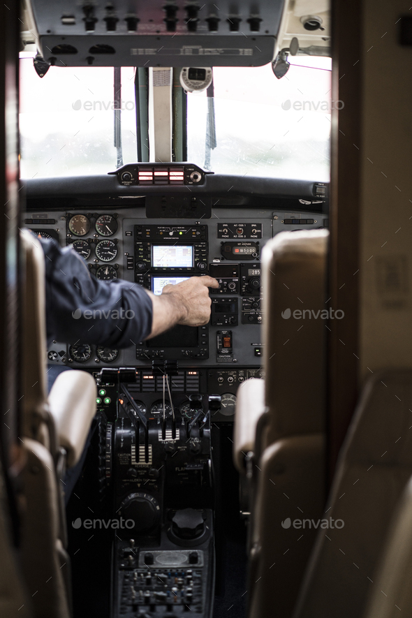 Faceless pilot flying modern aircraft Stock Photo by ADDICTIVE_STOCK
