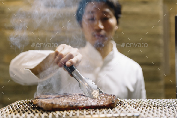 Chef cooking in restaurant preparing beef roast Stock Photo by ...