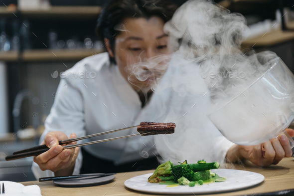 Chef cooking in restaurant with smoke dish Stock Photo by ADDICTIVE_STOCK