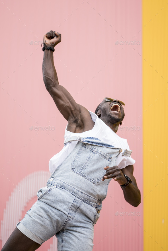 African man shouting victory clenched fist. Stock Photo by ADDICTIVE_STOCK