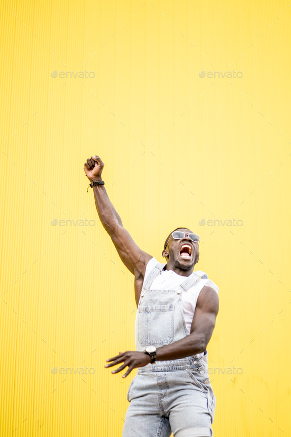African man shouting victory clenched fist. Stock Photo by ADDICTIVE_STOCK