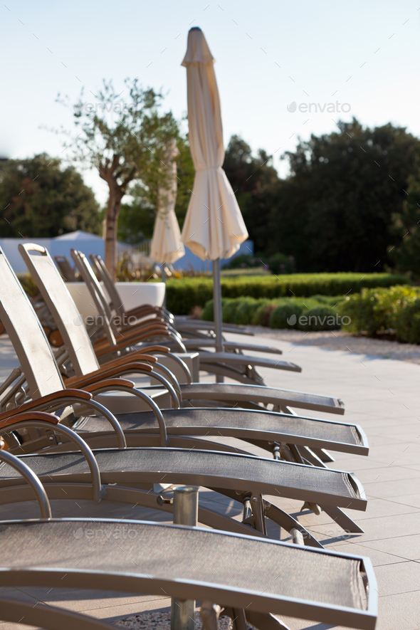Hotel Poolside Chairs Row Stock Photo by nzooo | PhotoDune