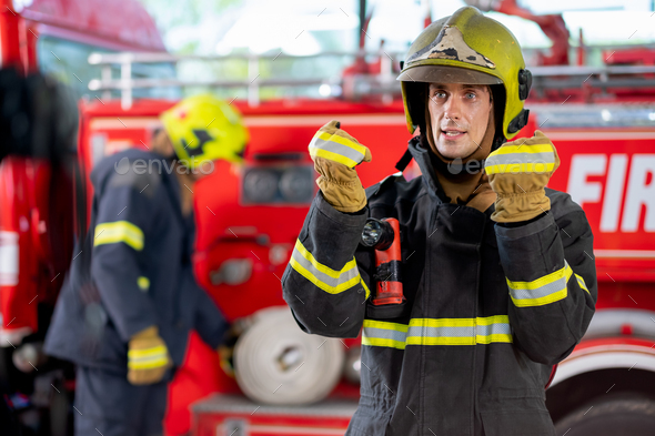 Fireman or firefighter stand and show some action look like he report ...