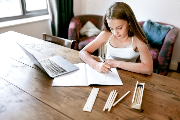 Blond girl having online class, homeschooling in the new normal Stock ...