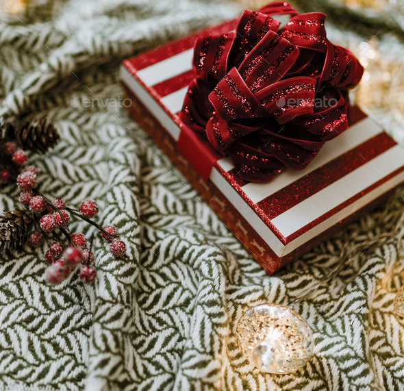 Christmas themed gift box with a poinsettia Stock Photo by Rawpixel