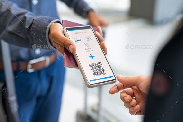 Man showing digital flight e-ticket to stewardess Stock Photo by Rido81