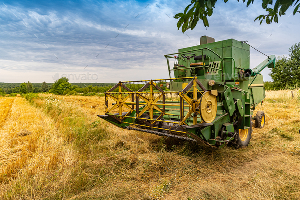 Old green combine harvester Stock Photo by grafvision | PhotoDune