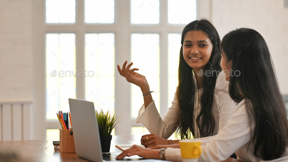 University students are sitting together in front of a computer laptop ...