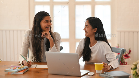 University students are sitting together in front of a computer laptop ...