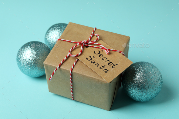 Secret Santa gift box with baubles on blue background Stock Photo by ...