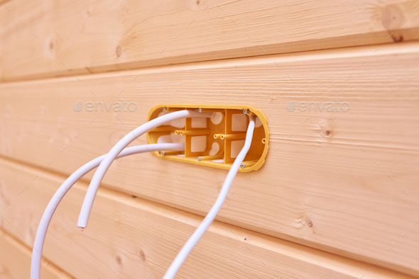 installation of electrical wiring socket inside a wooden house Stock ...