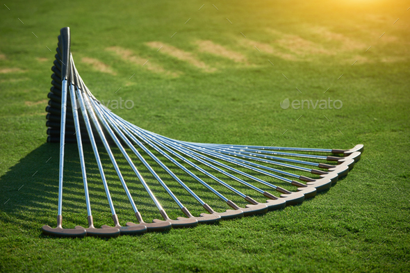 stack of golf clubs on a golf course Stock Photo by Sandsun | PhotoDune