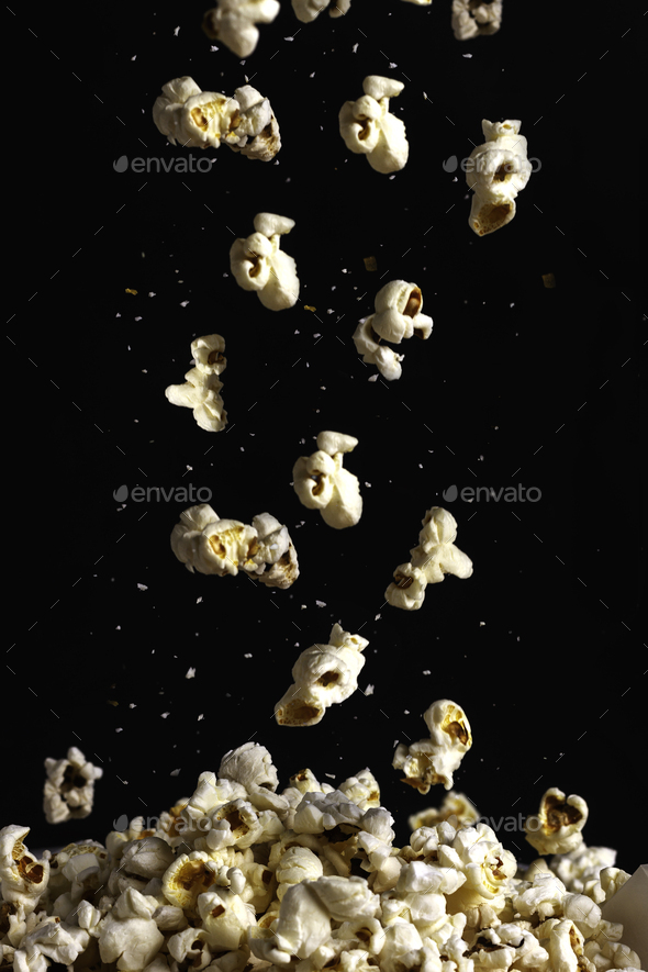 Popcorn falling down in black background Stock Photo by ADDICTIVE_STOCK