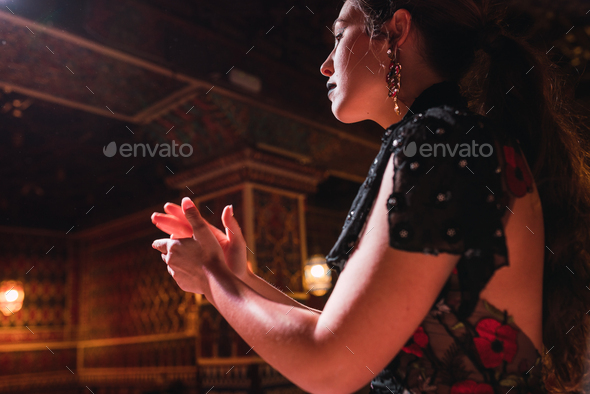 Woman clapping hands and dancing on scene Stock Photo by ADDICTIVE_STOCK