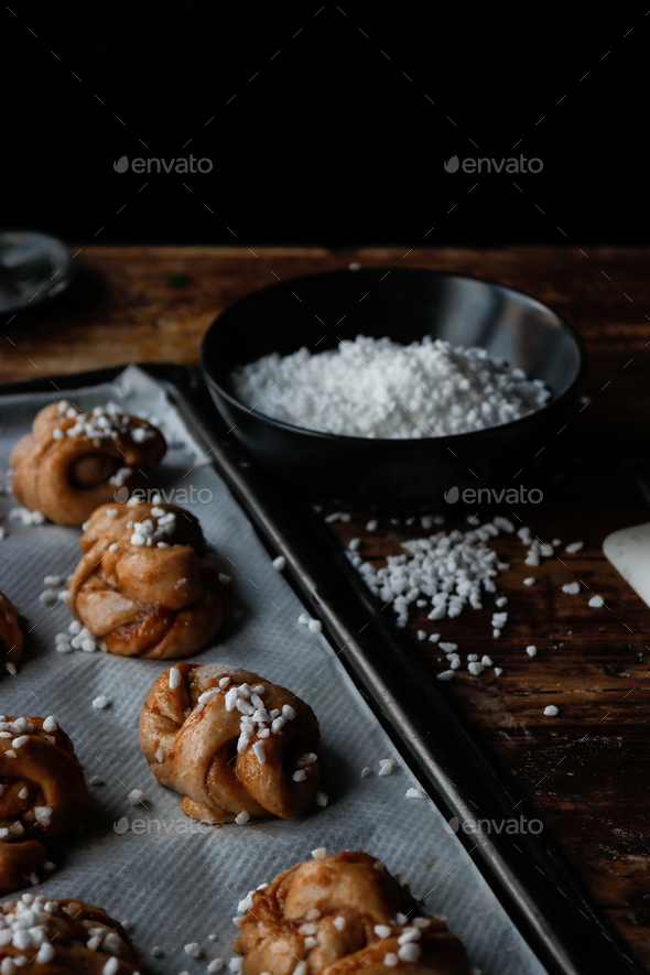 Sugar and cutter near cardamom buns Stock Photo by ADDICTIVE_STOCK