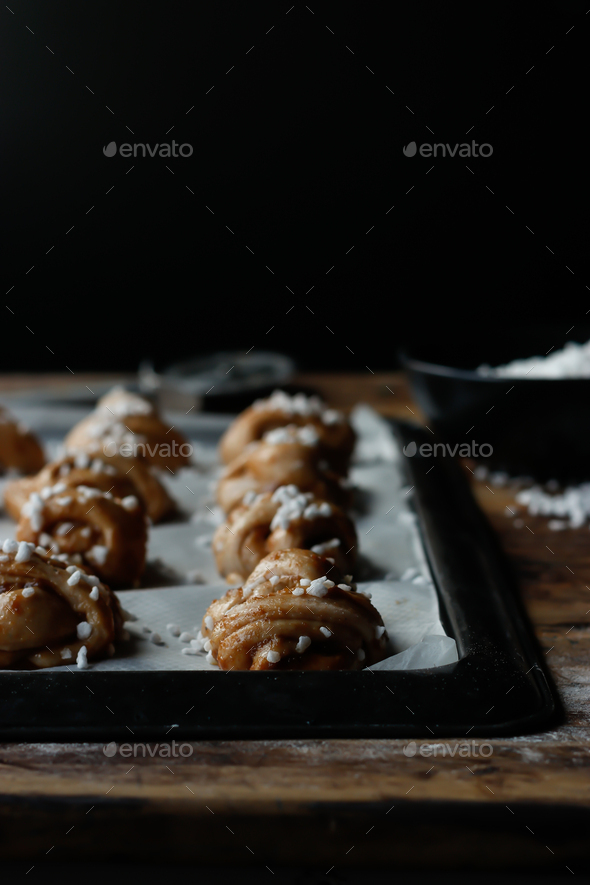 Sugar and cutter near cardamom buns Stock Photo by ADDICTIVE_STOCK