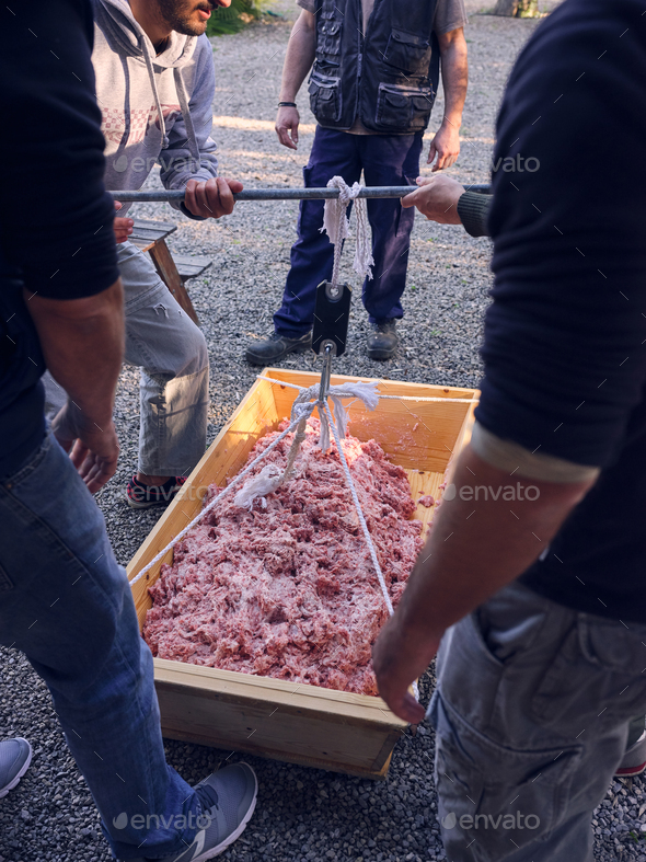 Crop men carrying trough with minced meat Stock Photo by ADDICTIVE_STOCK