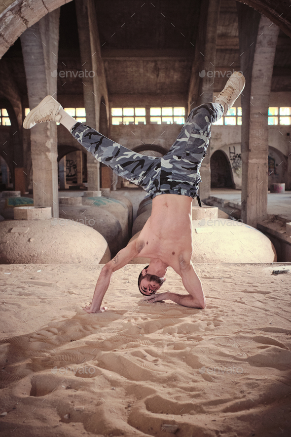 Shirtless man dancing on sand Stock Photo by ADDICTIVE_STOCK | PhotoDune