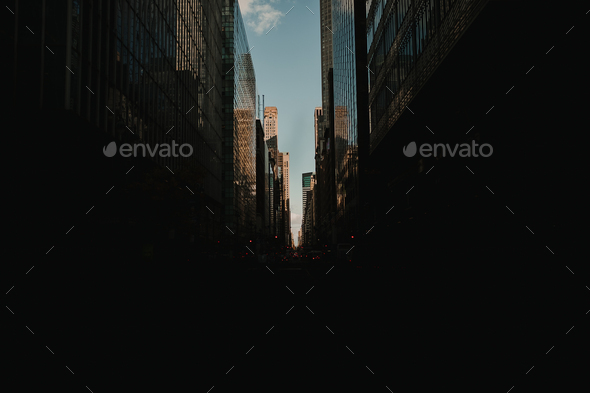 Dark perspective view of street among skyscrapers Stock Photo by ...