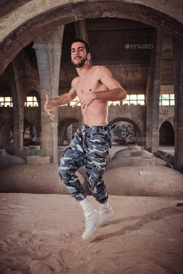 Shirtless man dancing on sand Stock Photo by ADDICTIVE_STOCK | PhotoDune
