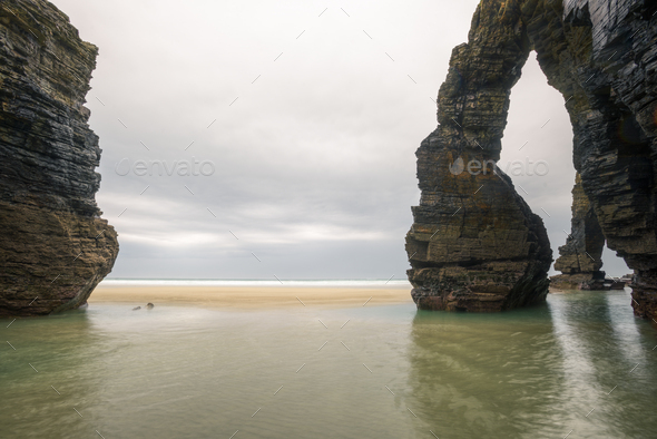Ponds left by the tide under the famous arches of As Catedrais beach ...