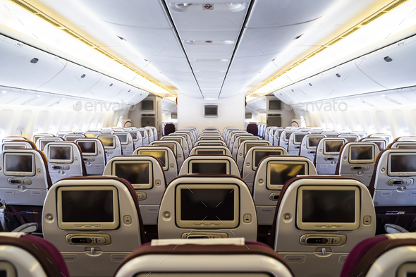 Cabin inside of commercial passenger wide body aircraft. Stock Photo by ...
