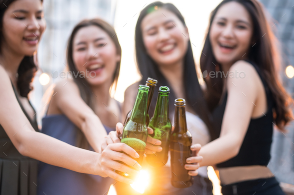 Group of Asian girl gang drinking beer alcohol and toasting bottle have ...