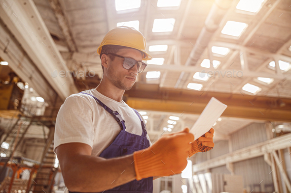Handsome man studying architectural plan at construction site Stock ...