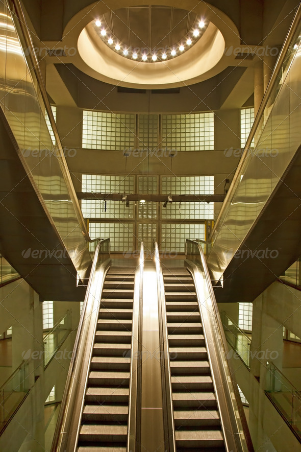 Golden interior escalator in business architecture Stock Photo by StevanZZ