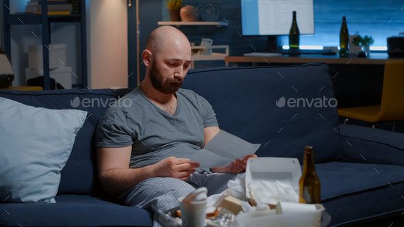 Desperate man reading eviction notice in letter ripping warning ...