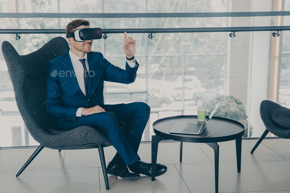 Overjoyed office worker wears VR headset, enjoying spending coffee ...
