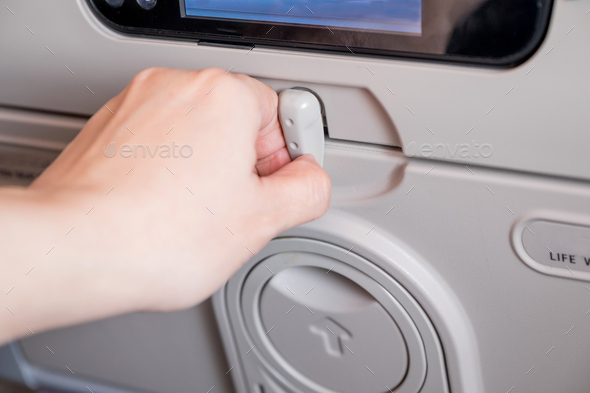 Hand open lock of food tray at back seat in airplane Stock Photo by ...