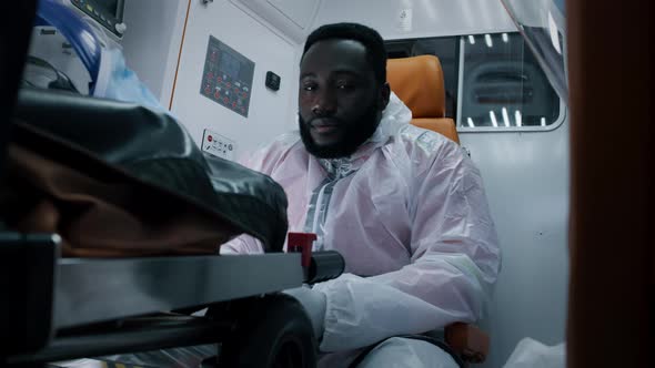 Exhausted African American Paramedic Riding Ambulance, Stock Footage