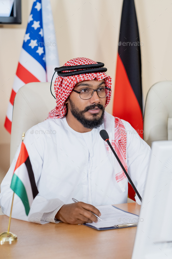 Islamic Politician Speaking Into Microphone Stock Photo by Pressmaster