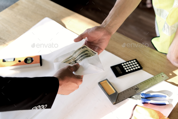 Top view of owner giving money to employee or hired person for his wage ...