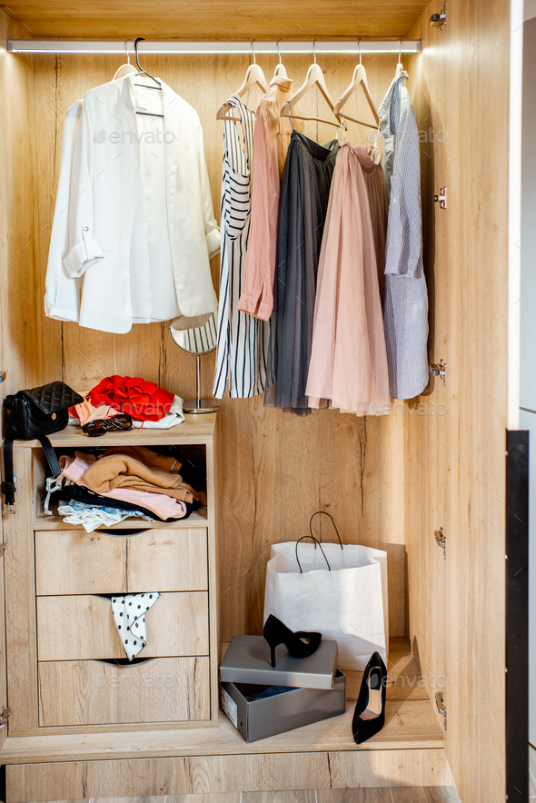 Wardrobe with female clothes Stock Photo by RossHelen | PhotoDune