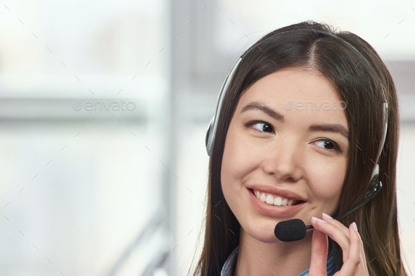 Friendly receptionist smiling and wearing a headset. Stock Photo by ...