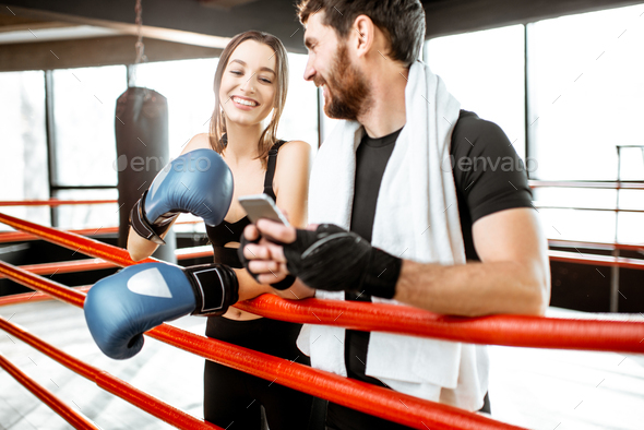 Couple after the training on the boxing ring Stock Photo by RossHelen
