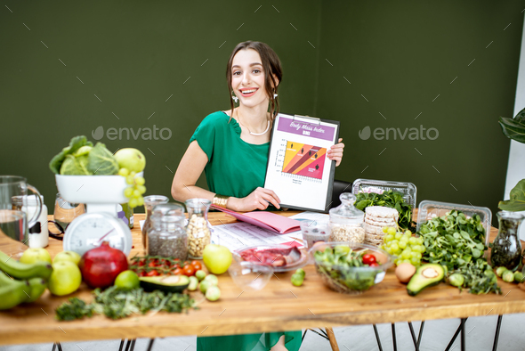 Portrait of the dietitian with healthy food in the office Stock Photo ...