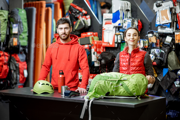 Sales man and woman in the sports shop Stock Photo by RossHelen | PhotoDune