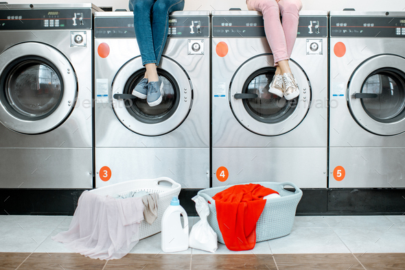 Washing machines with woman's legs and clothes in the laundry Stock ...