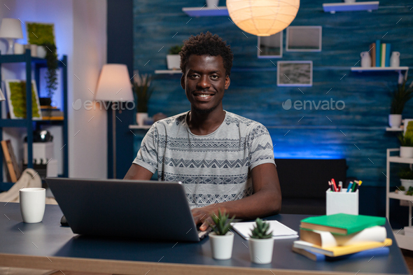 Man working from home office, browsing on laptop, typing using ...