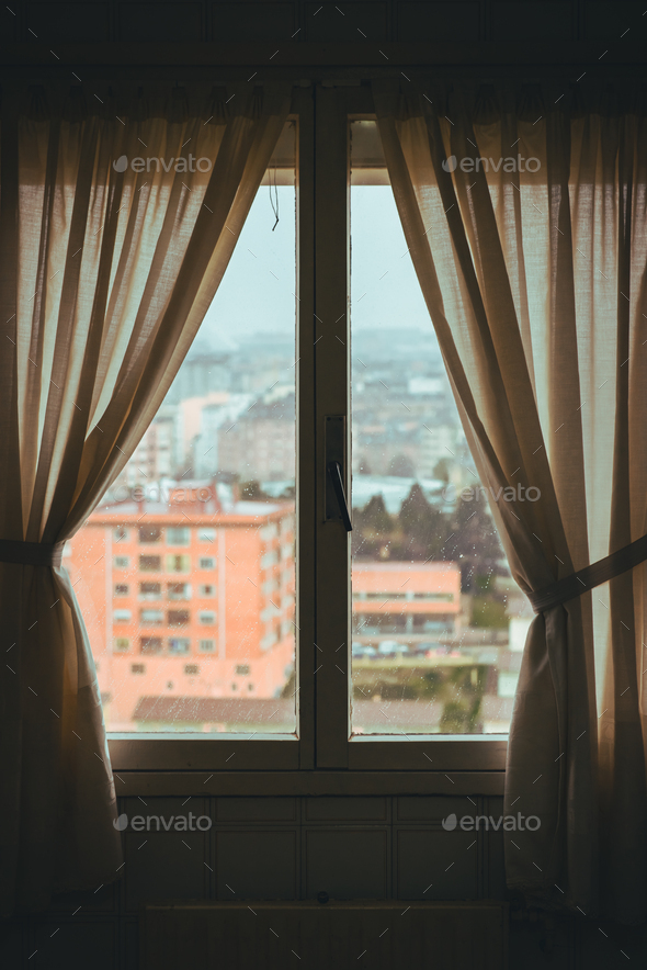 View of city through window from flat Stock Photo by ADDICTIVE_STOCK