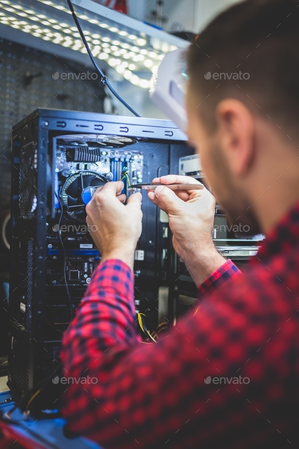 Man repairing PC at workplace Stock Photo by ADDICTIVE_STOCK | PhotoDune
