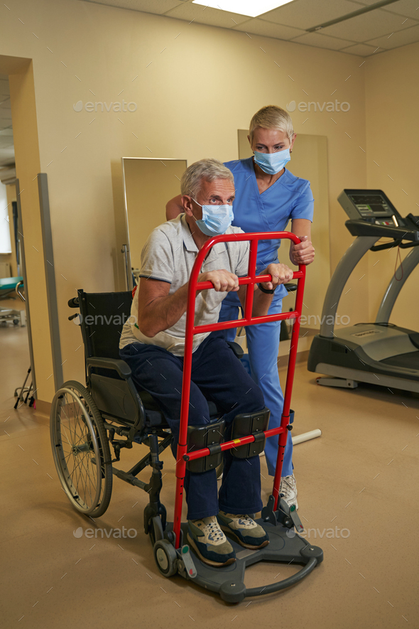 Stroke patient restoring mobility skills in rehab center Stock Photo by ...