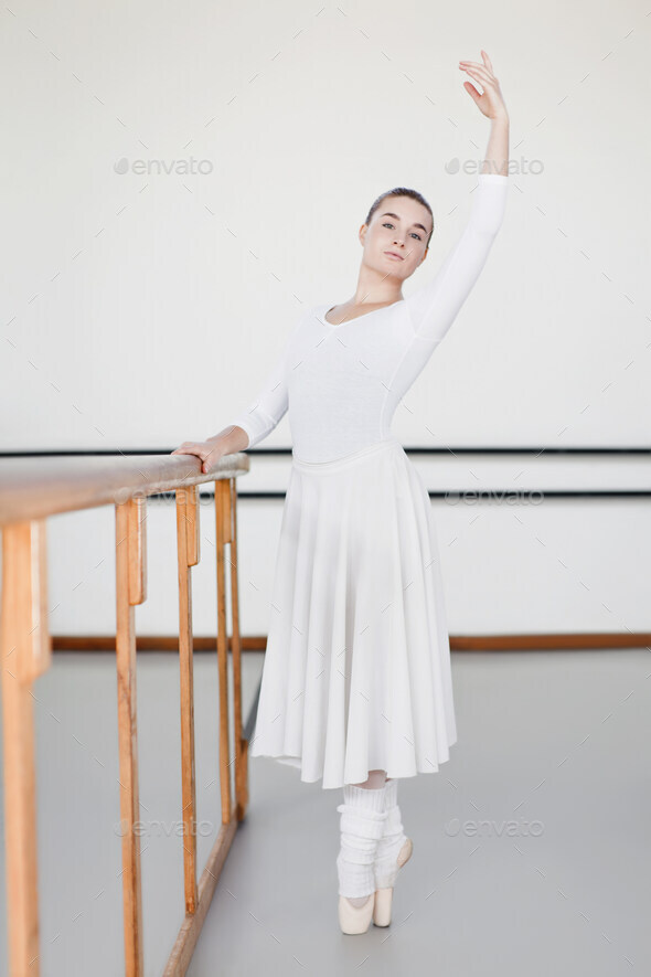 Ballet dancer posing at barre Stock Photo by nualaimages | PhotoDune